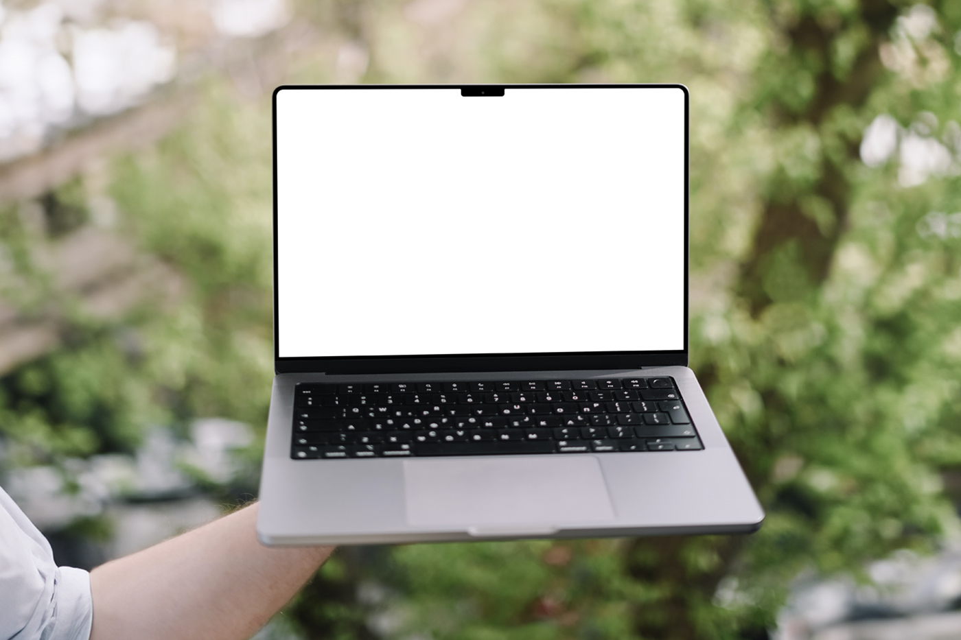 Free Arm Holding MacBook Pro Mockup — Mr.Mockup