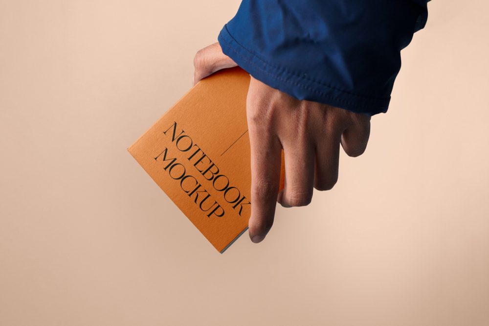 Free A5 Notebook in Hand Mockup — Mr.Mockup