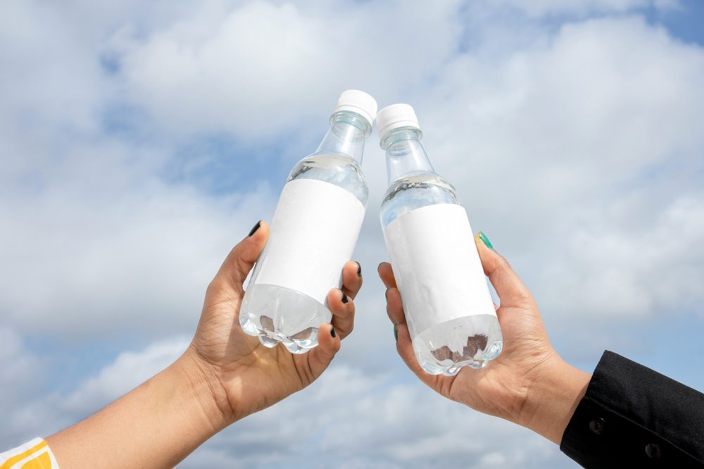 Free Two Bottle in Hand Mockups — Mr.Mockup